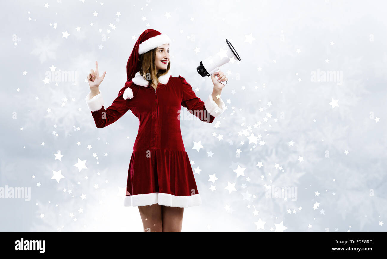 Young attractive Santa girl listening music in headphones Stock Photo ...