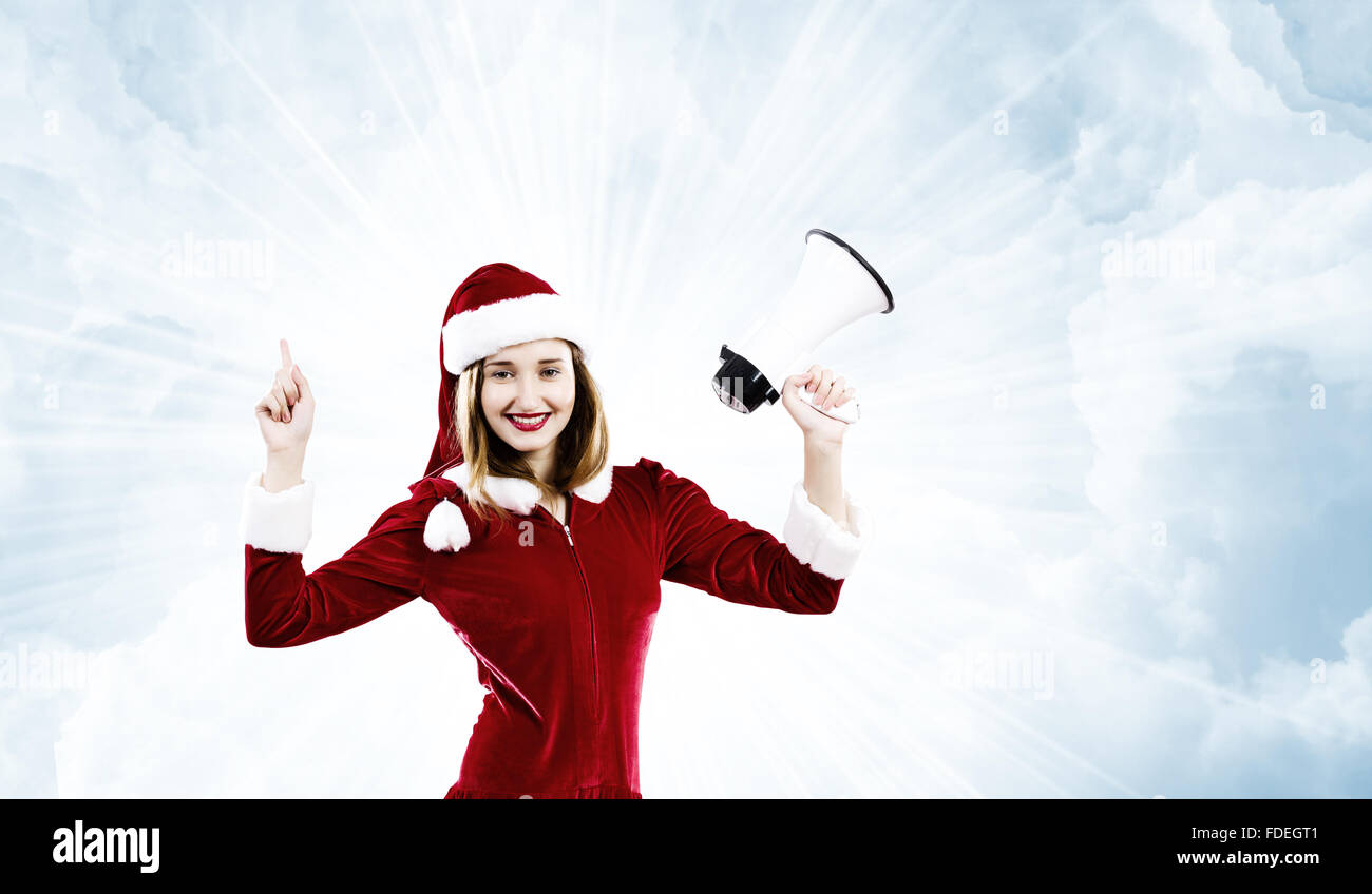 Young attractive Santa girl listening music in headphones Stock Photo ...