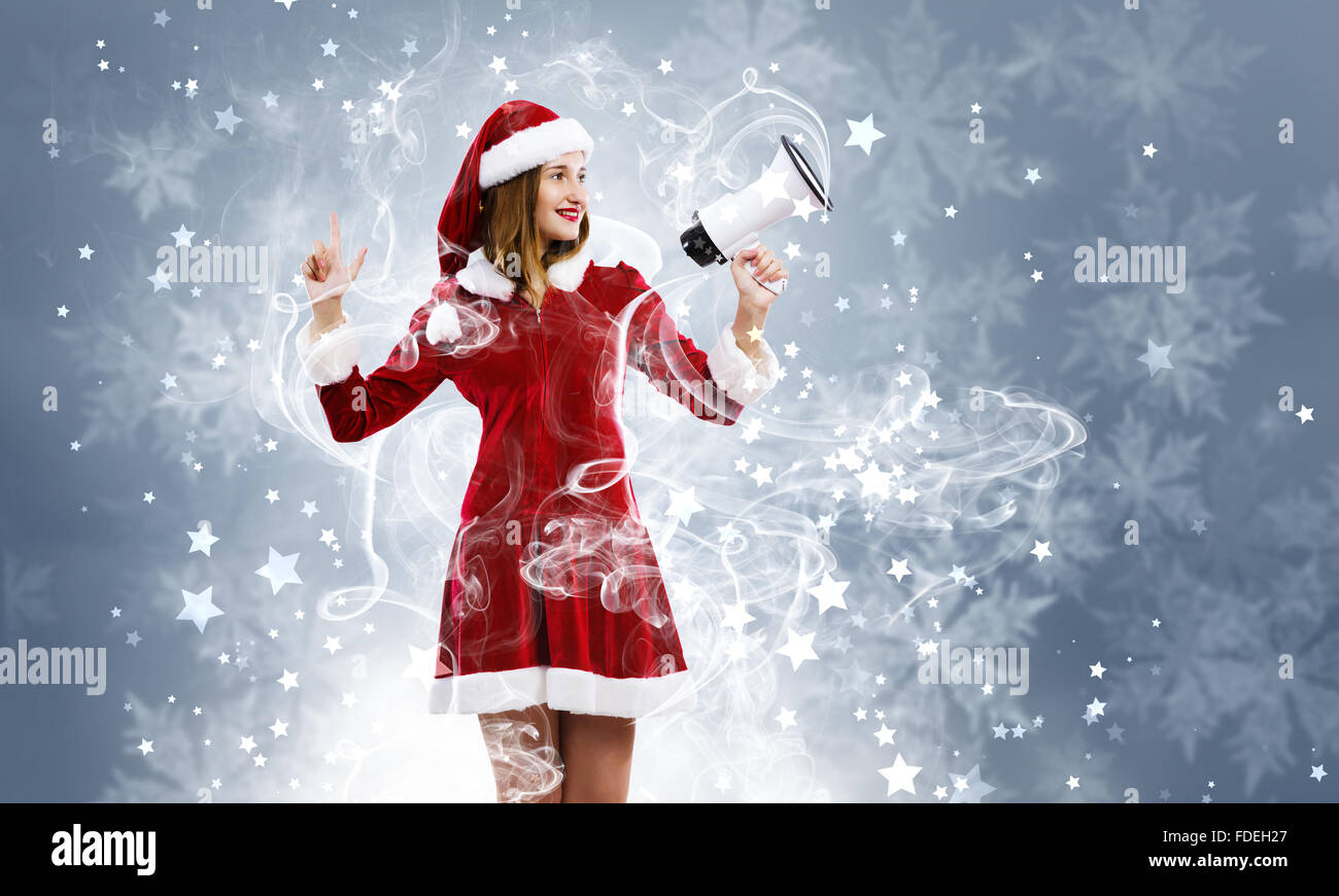Young attractive Santa girl listening music in headphones Stock Photo ...