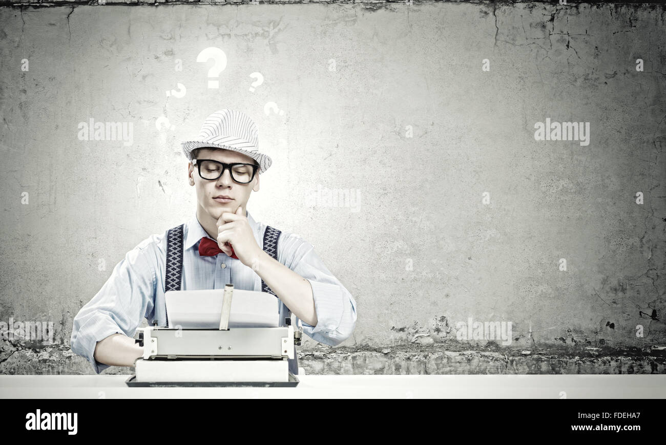 Young funny man in glasses writing on typewriter Stock Photo - Alamy