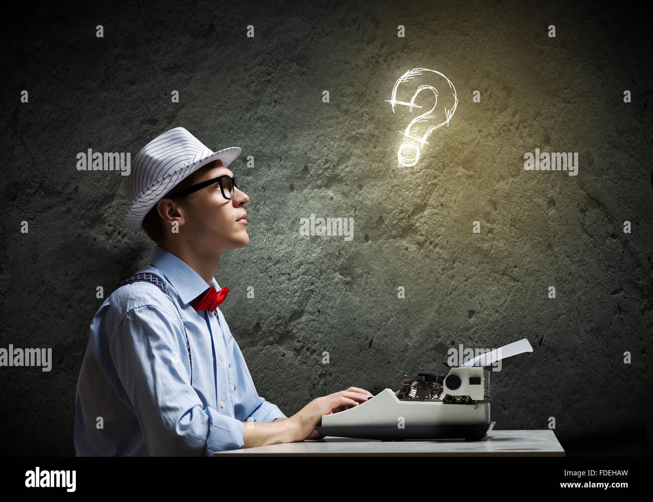 Young funny man in glasses writing on typewriter Stock Photo - Alamy