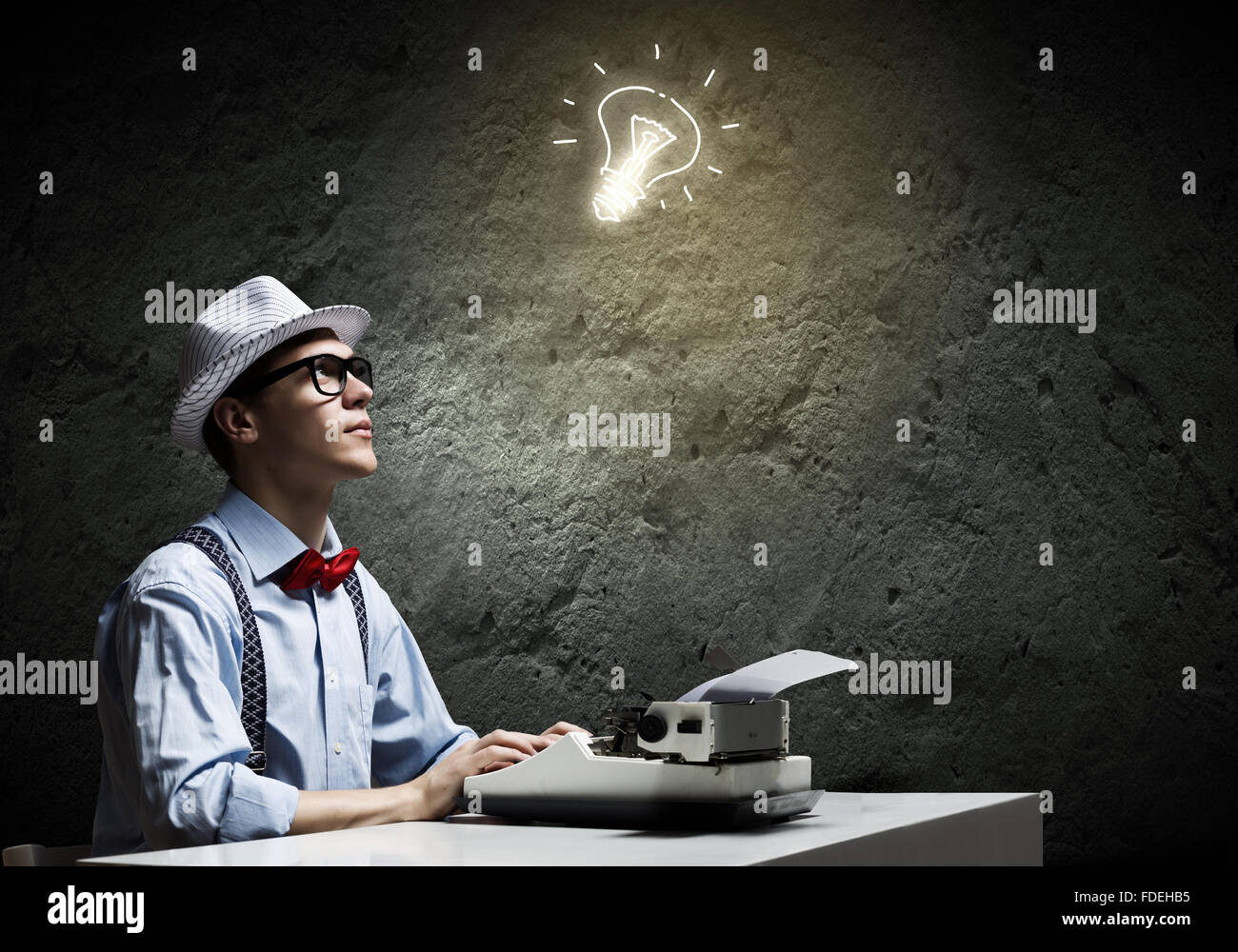 Young funny man in glasses writing on typewriter Stock Photo - Alamy