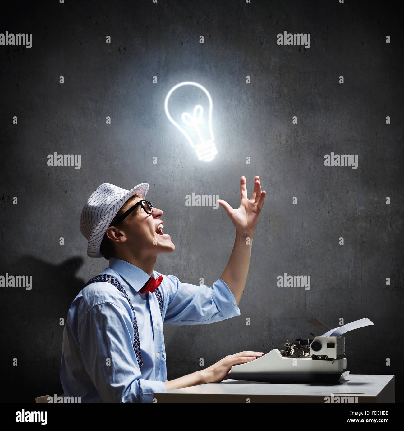 Young funny man in glasses writing on typewriter Stock Photo - Alamy