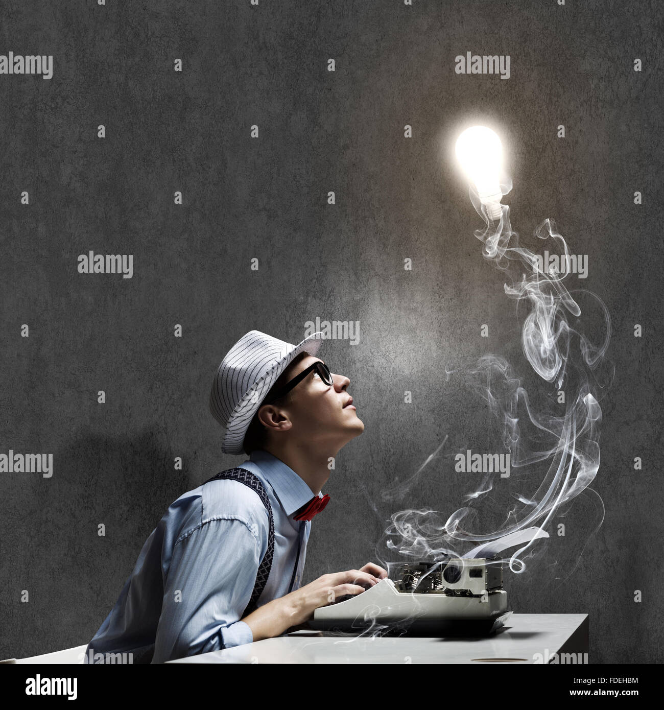 Young funny man in glasses writing on typewriter Stock Photo - Alamy