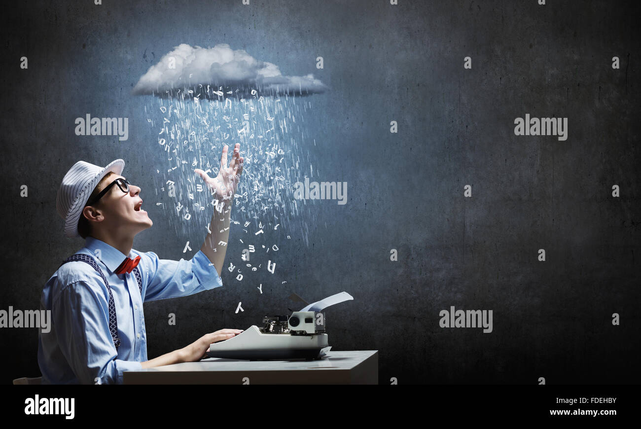 Young funny man in glasses writing on typewriter Stock Photo - Alamy