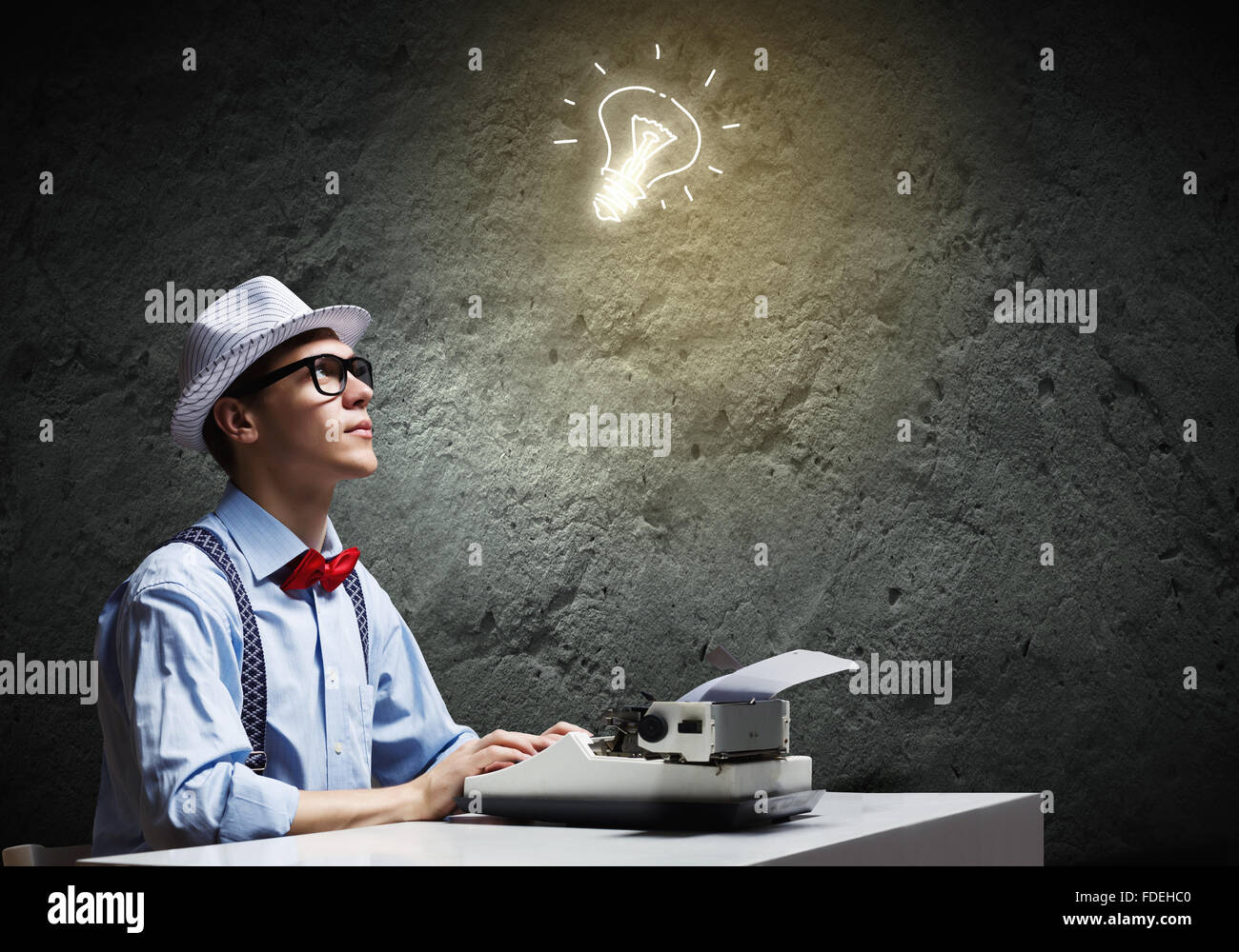Young funny man in glasses writing on typewriter Stock Photo - Alamy