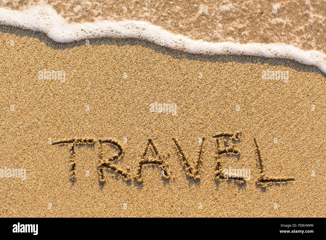 TRAVEL - word drawn on the sand beach with the soft wave. Travel ...