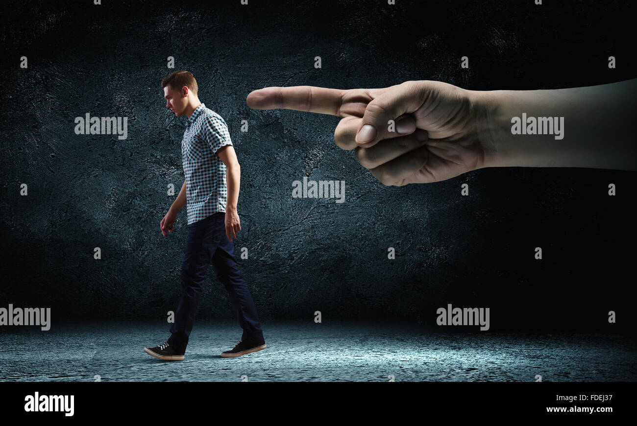 Funny image of young man and huge hand Stock Photo - Alamy