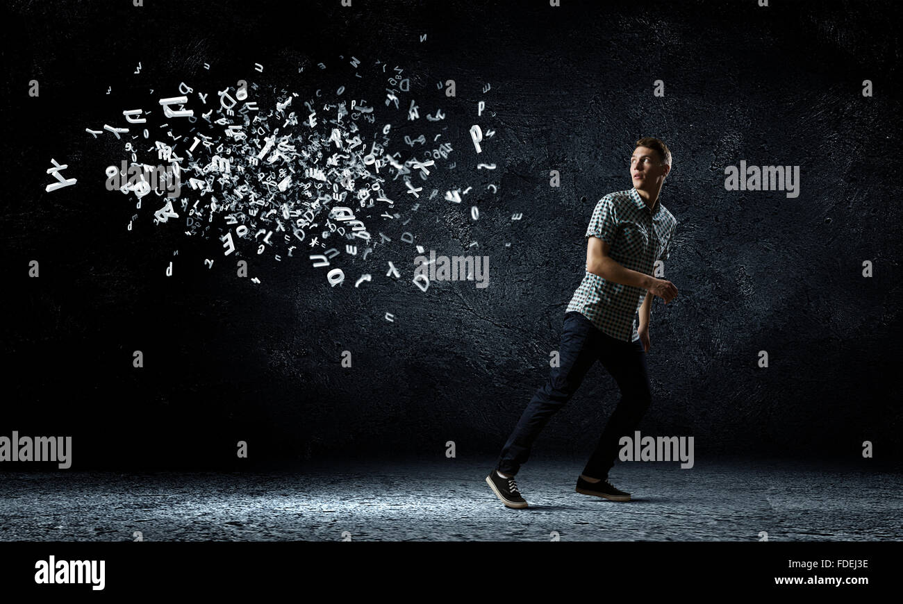 Funny image of young man trying to escape from flying letters Stock ...