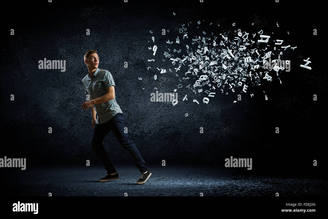 Funny image of young man trying to escape from flying letters Stock ...