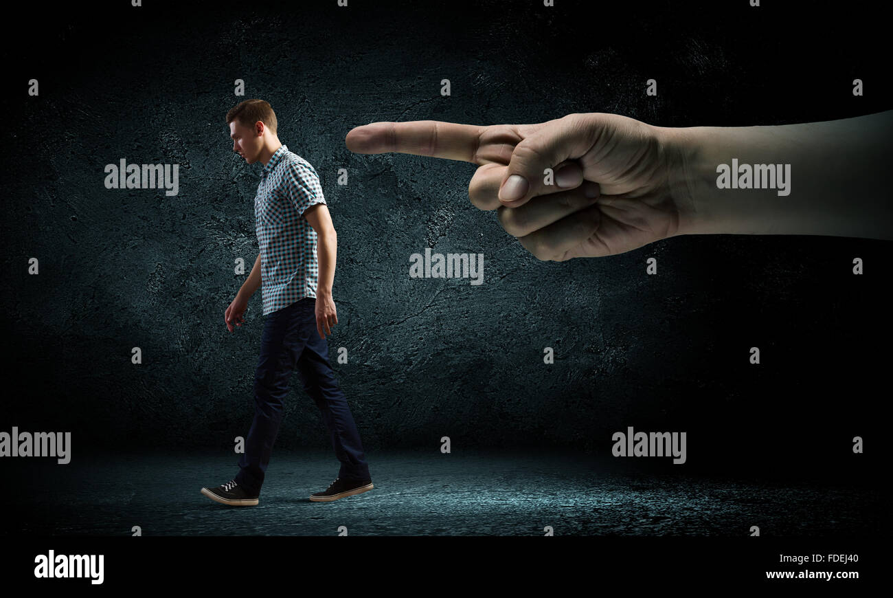 Funny image of young man and huge hand Stock Photo - Alamy
