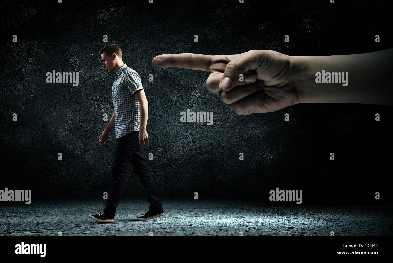 Funny image of young man and huge hand Stock Photo - Alamy