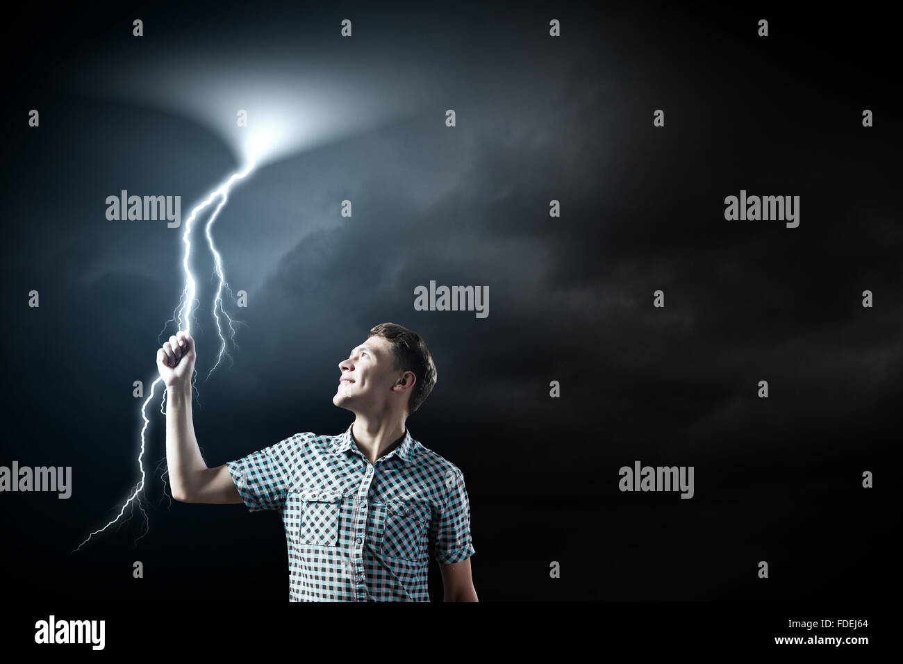 Young man touching illustration of lightning in sky Stock Photo - Alamy
