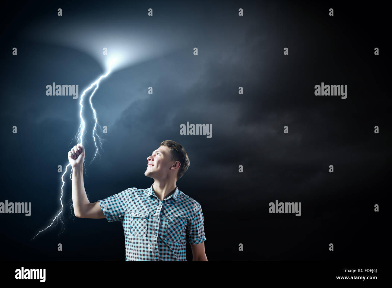 Young man touching illustration of lightning in sky Stock Photo - Alamy