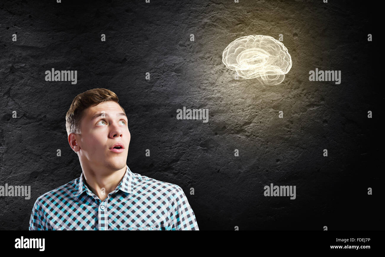 Young man and brain illustration against dark background Stock Photo ...