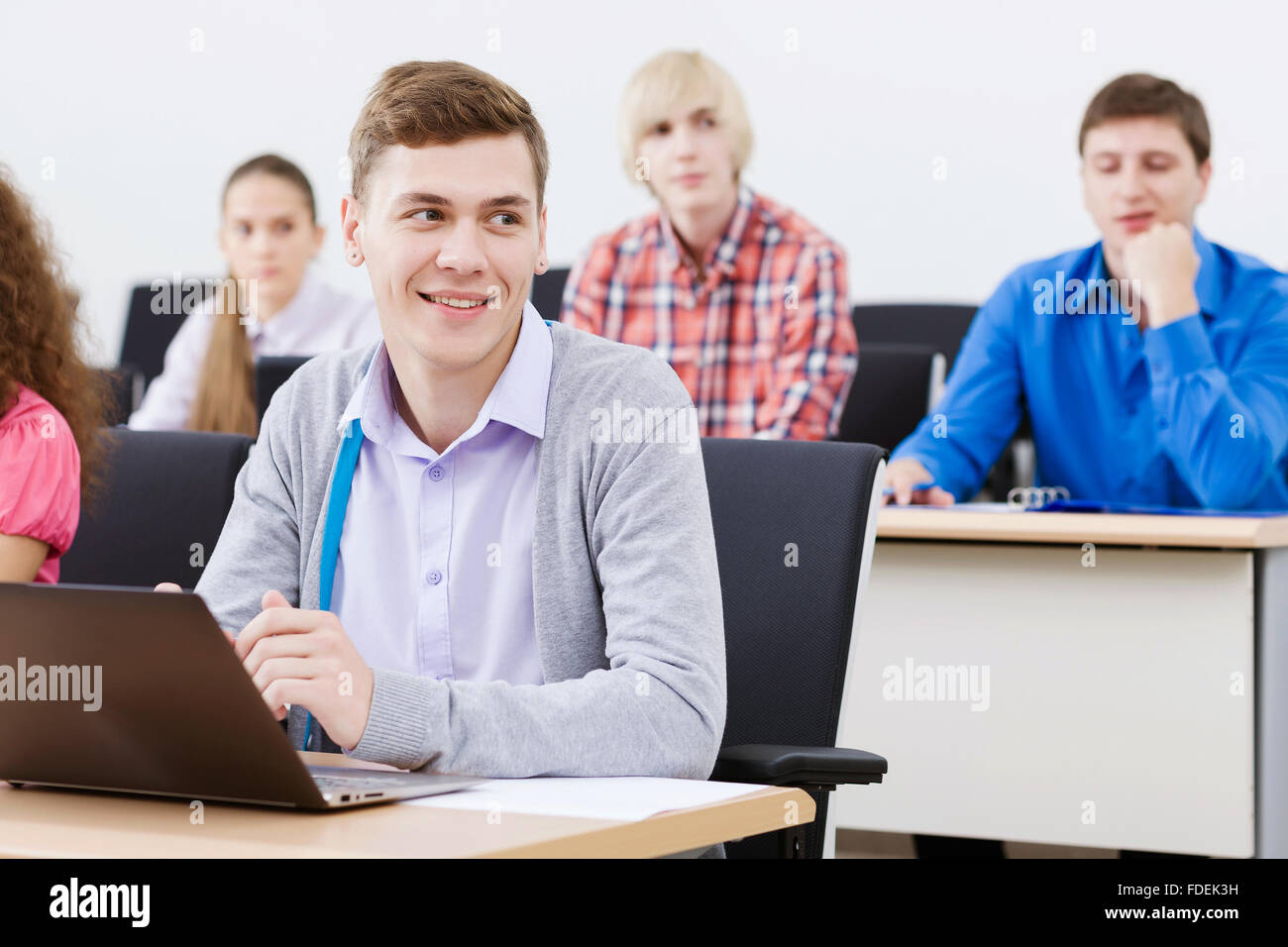 Young people sitting in classroom at lecture Stock Photo - Alamy