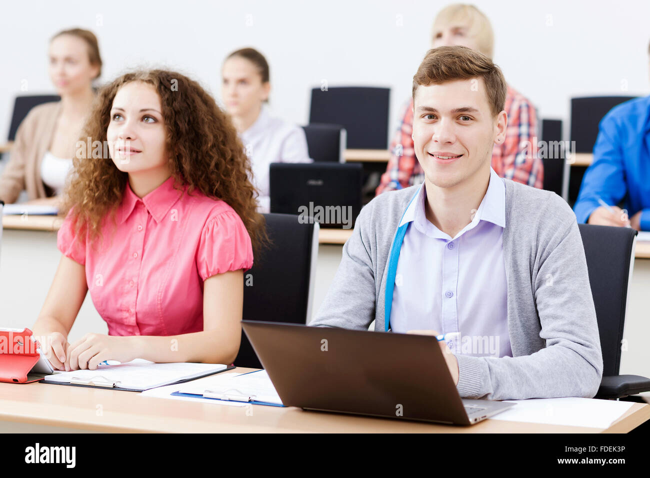 Young people sitting in classroom at lecture Stock Photo - Alamy