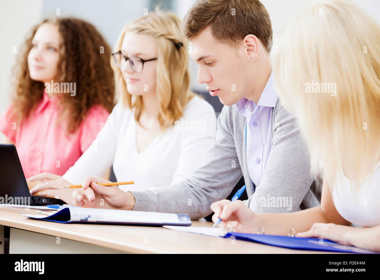 Young people sitting in classroom at lecture Stock Photo - Alamy