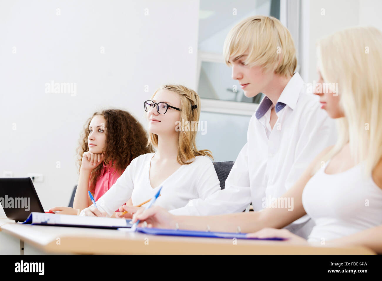 Young people sitting in classroom at lecture Stock Photo - Alamy