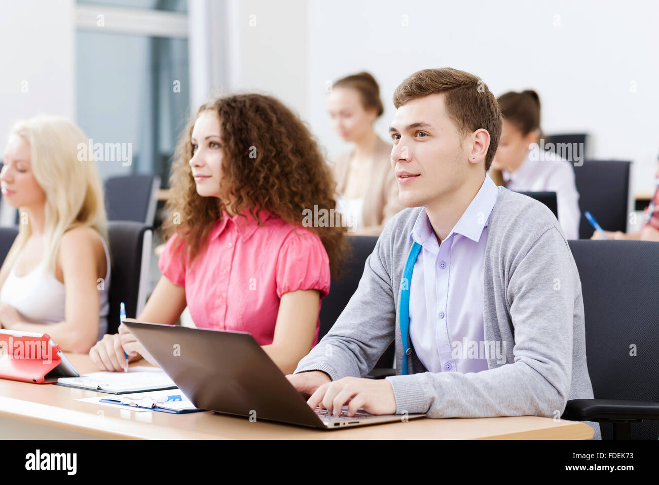 Young people sitting in classroom at lecture Stock Photo - Alamy