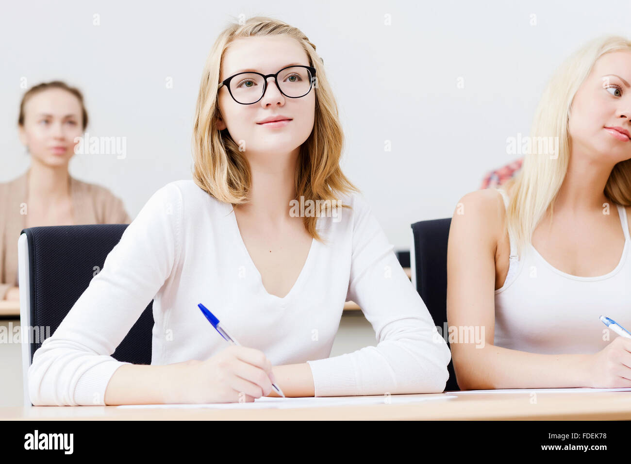 Young people sitting in classroom at lecture Stock Photo - Alamy