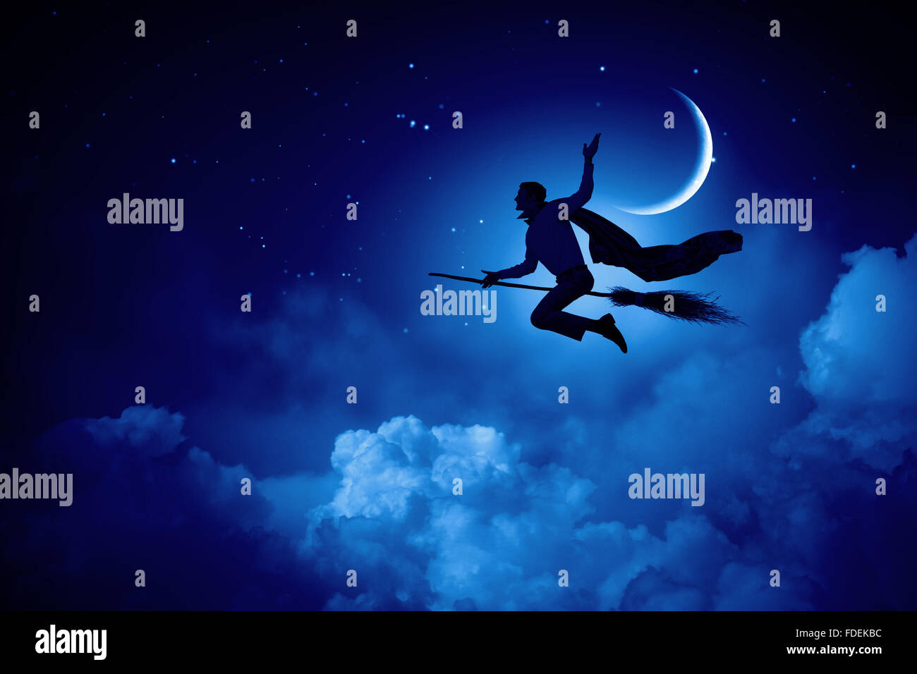 Young businessman flying on broom high in sky Stock Photo - Alamy