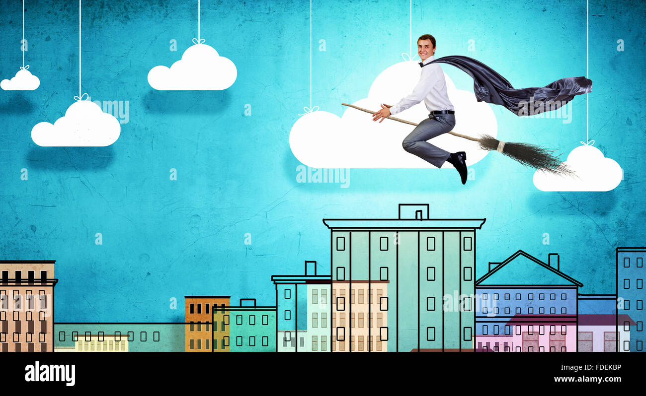 Young businessman flying on broom high in sky Stock Photo - Alamy