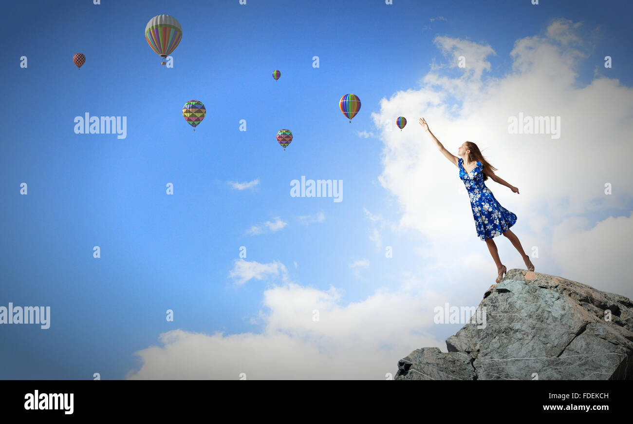 Happy young woman dreaming to fly in sky Stock Photo - Alamy
