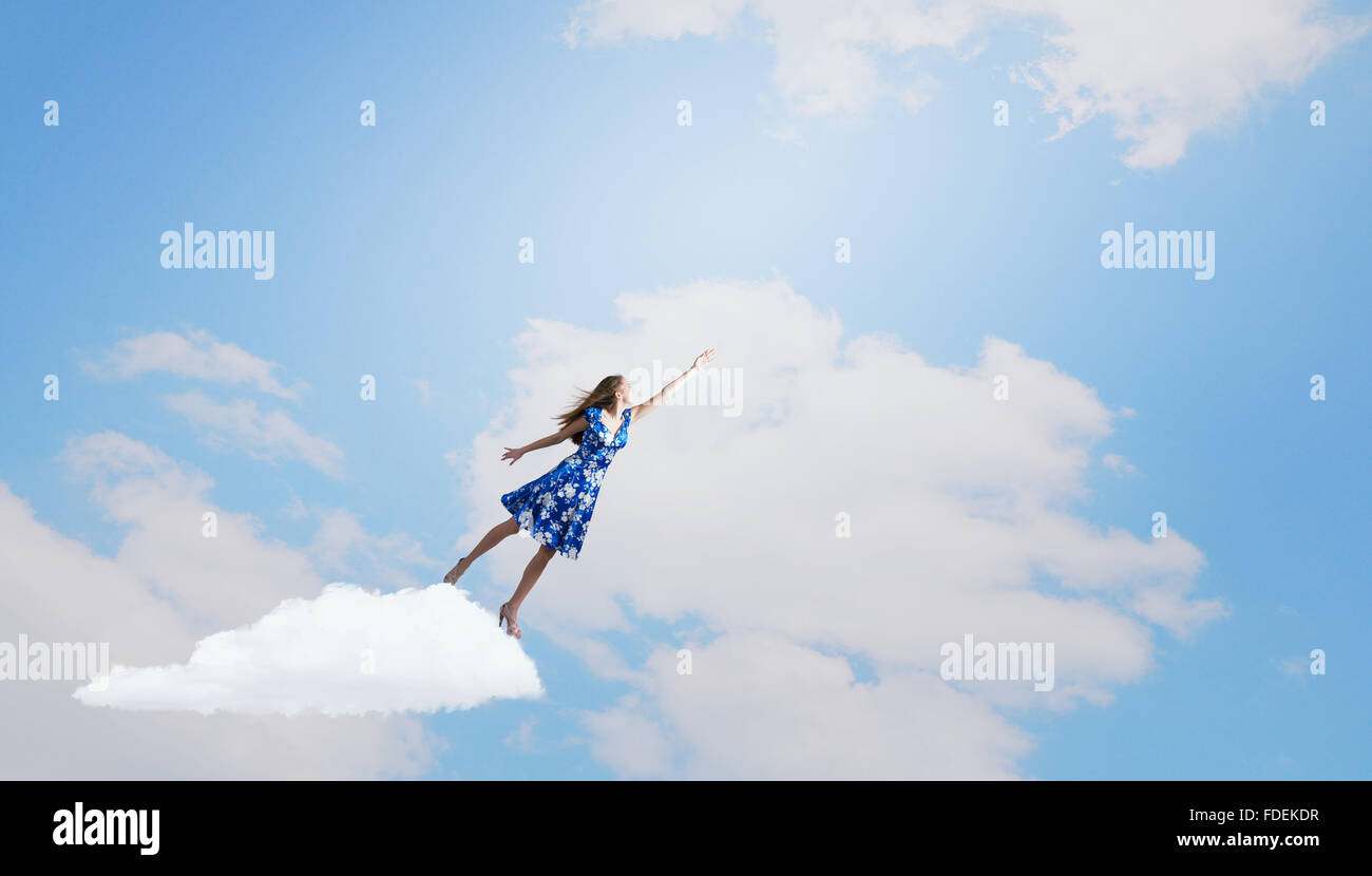 Happy young woman dreaming to fly in sky Stock Photo - Alamy