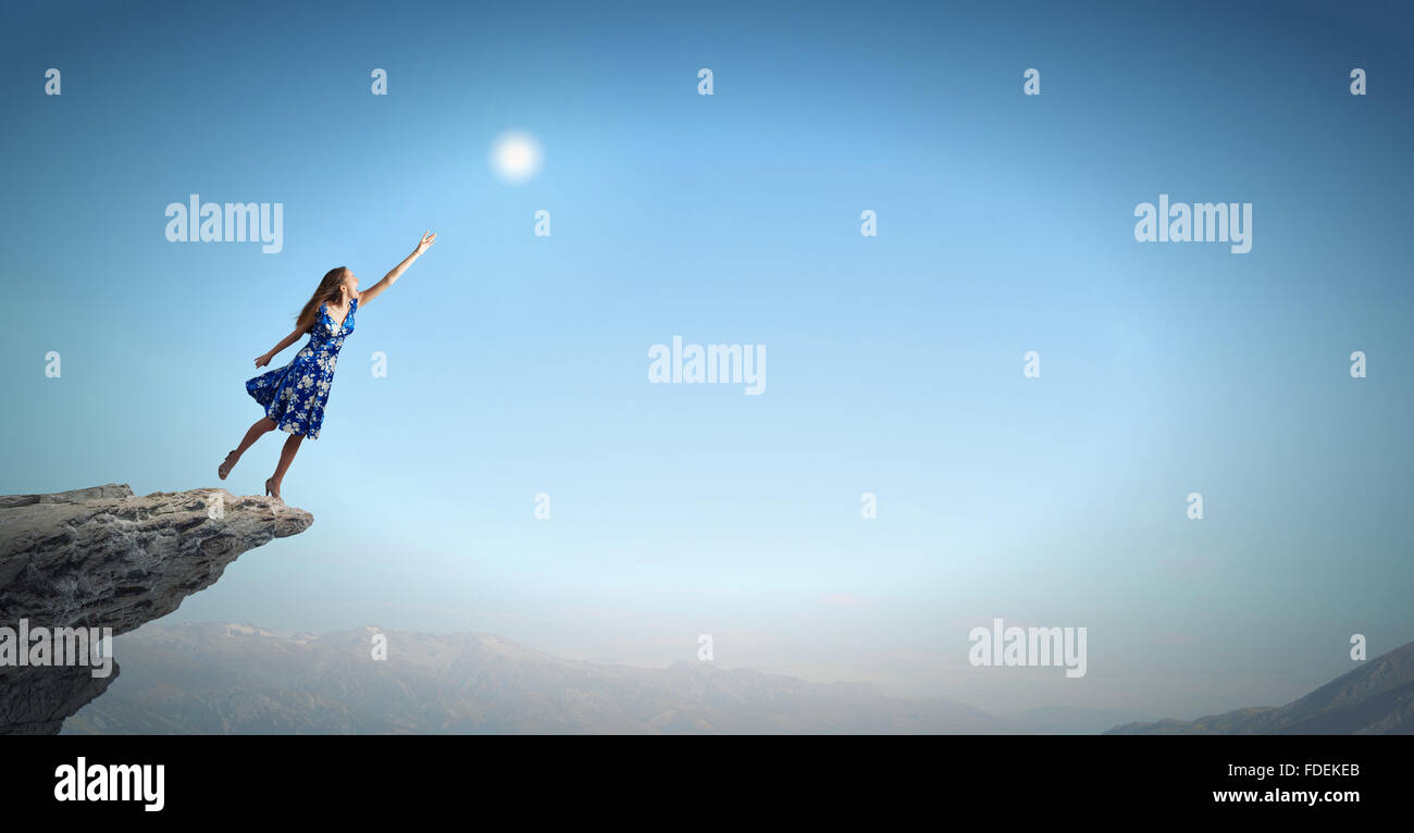 Happy young woman dreaming to fly in sky Stock Photo - Alamy