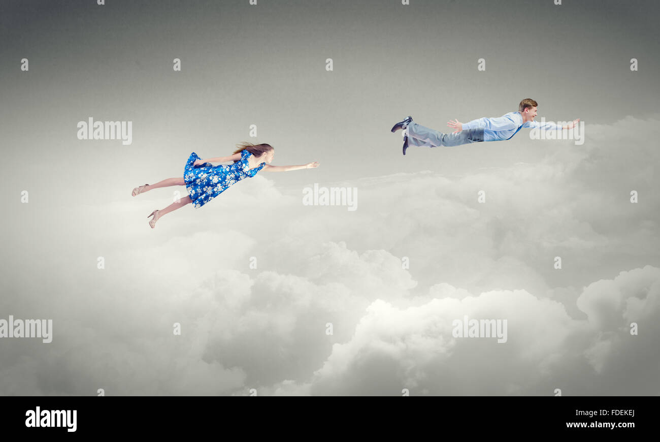Happy young woman dreaming to fly in sky Stock Photo - Alamy