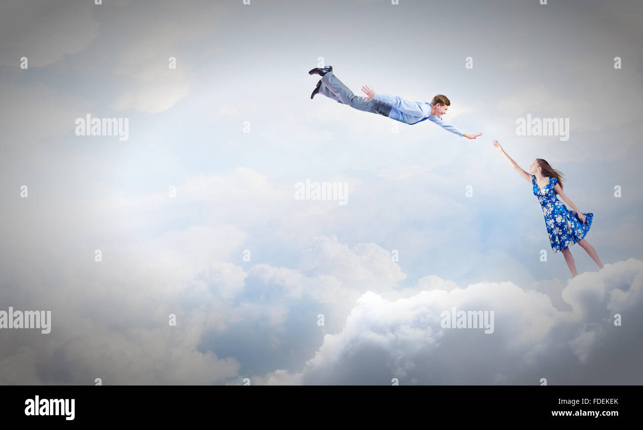 Happy young woman dreaming to fly in sky Stock Photo - Alamy