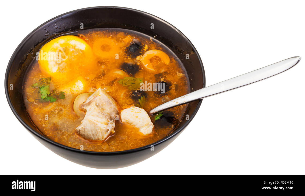 Solyanka russian traditional spicy and sour soup with fish in bowl with ...