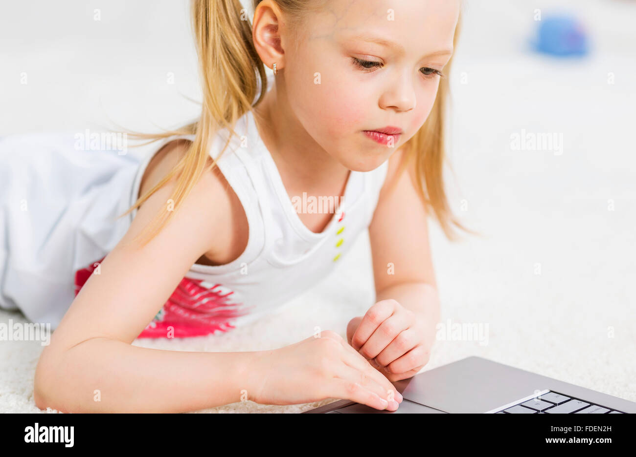 Young girl laying floor hi-res stock photography and images - Alamy