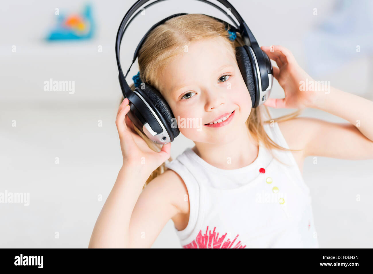 Cute adorable girl wearing headphones and enjoying music Stock Photo ...