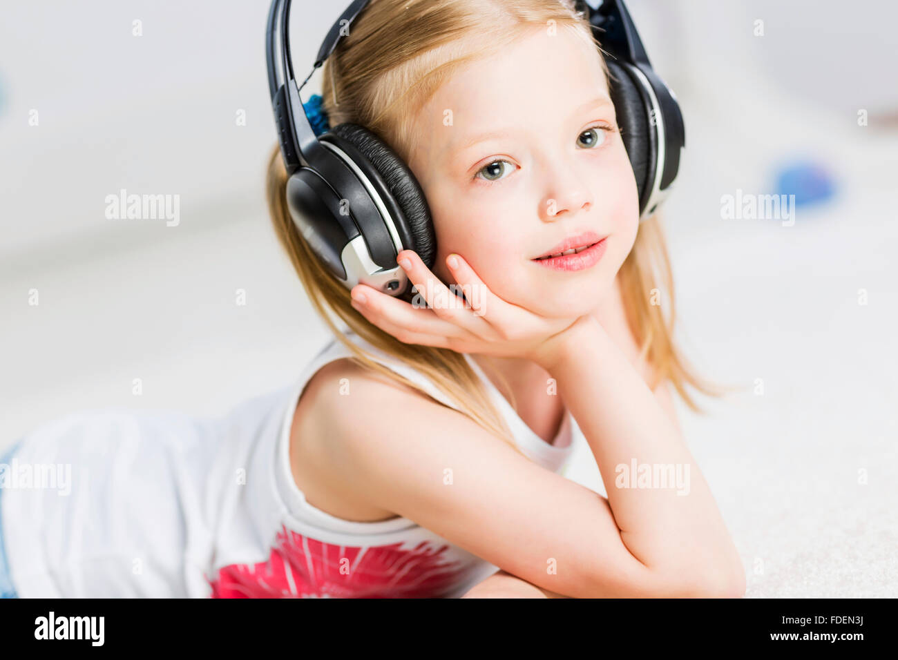 Cute adorable girl wearing headphones and enjoying music Stock Photo ...