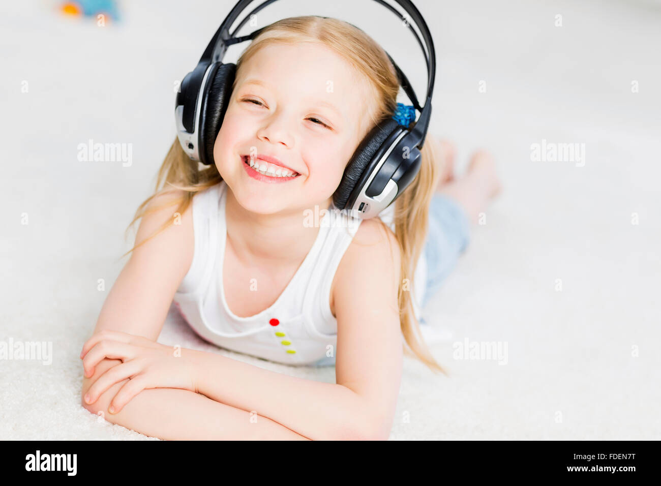 Cute adorable girl wearing headphones and enjoying music Stock Photo ...