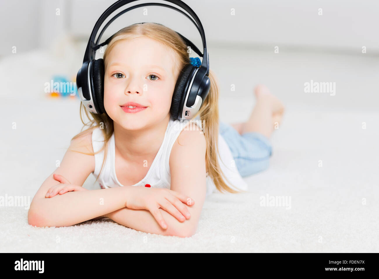 Cute adorable girl wearing headphones and enjoying music Stock Photo ...