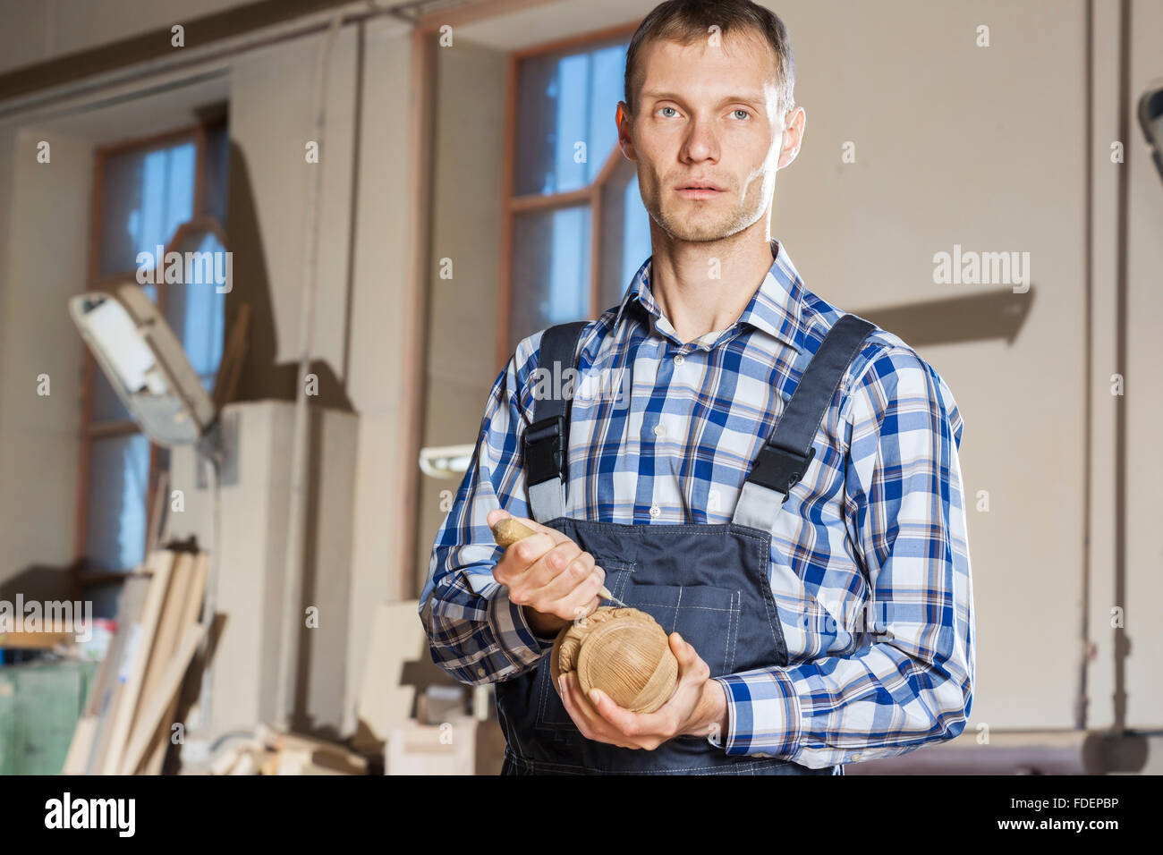 Young carpenter working with cutter in his studio Stock Photo - Alamy