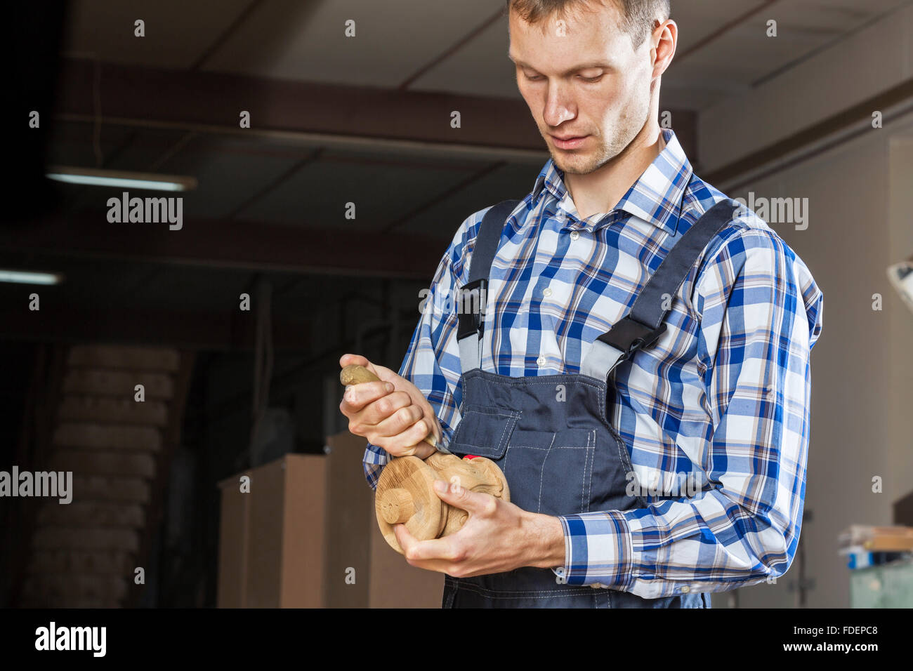 Young carpenter working with cutter in his studio Stock Photo - Alamy