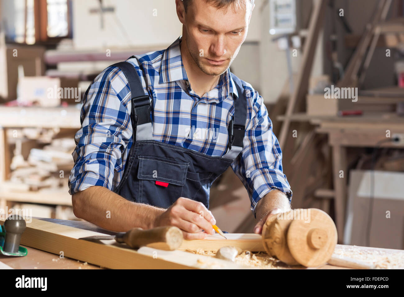 Young carpenter working with cutter in his studio Stock Photo - Alamy