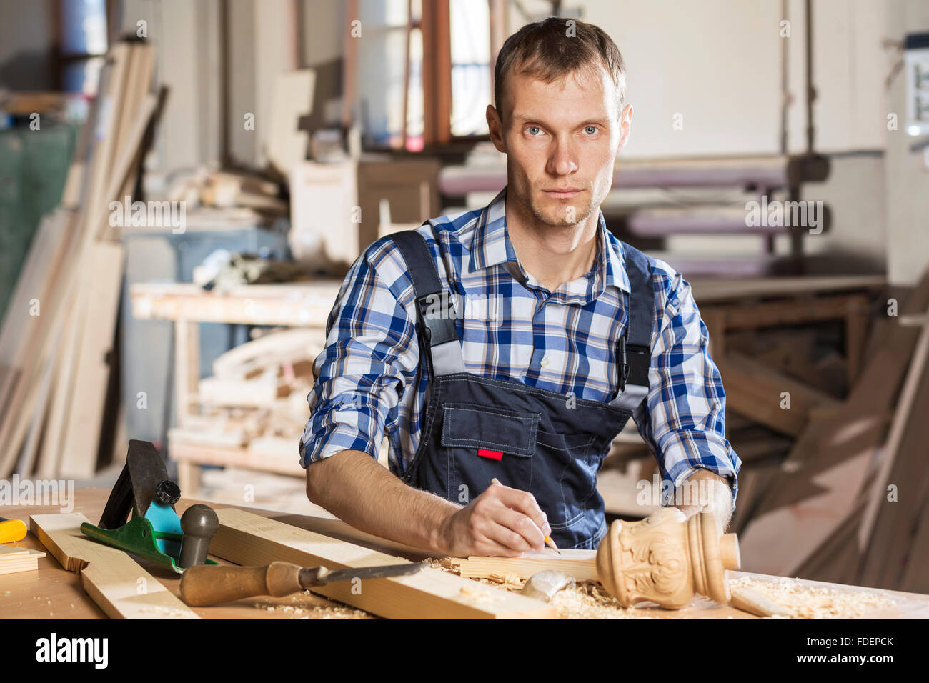 Young carpenter working with cutter in his studio Stock Photo - Alamy