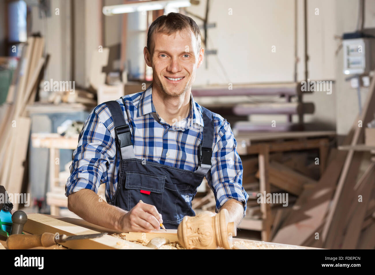 Young carpenter working with cutter in his studio Stock Photo - Alamy