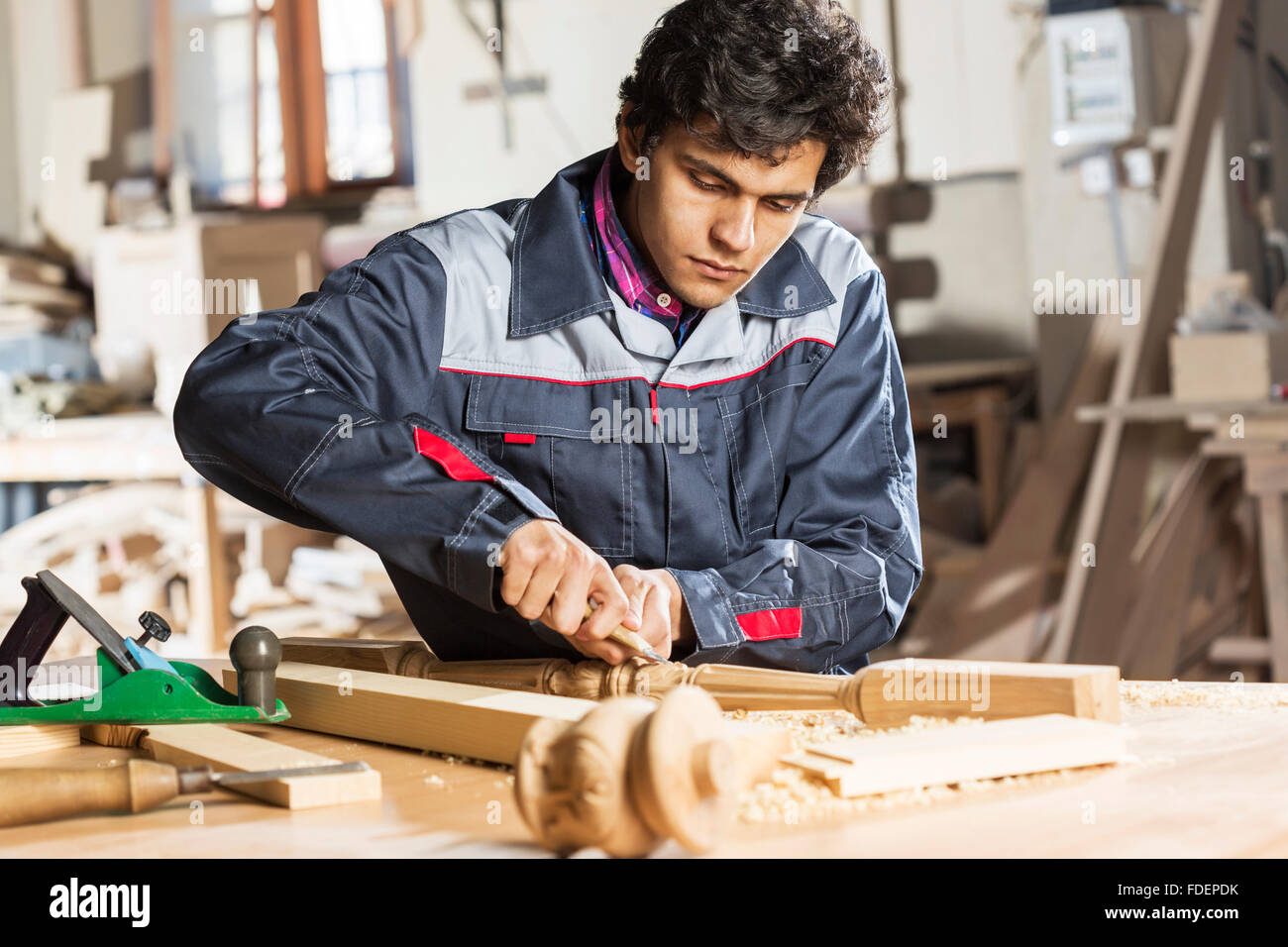 Young carpenter working with cutter in his studio Stock Photo - Alamy