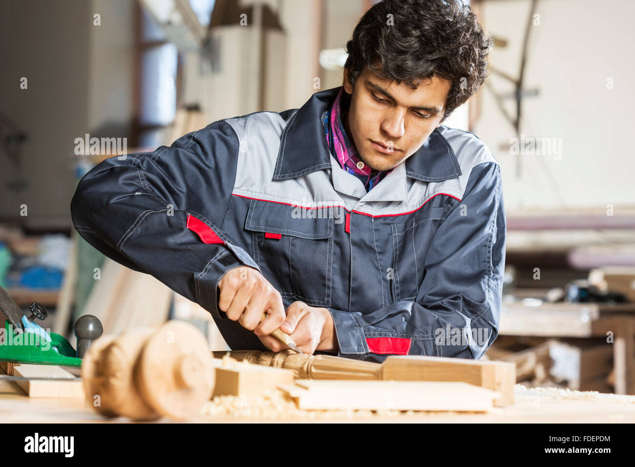 Young carpenter working with cutter in his studio Stock Photo - Alamy