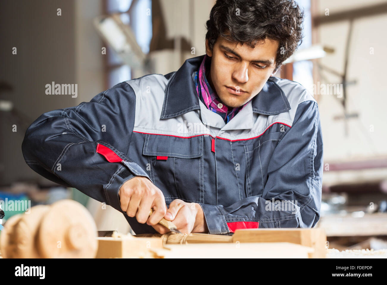 Young carpenter working with cutter in his studio Stock Photo - Alamy