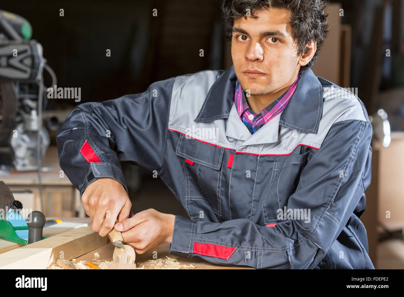 Young carpenter working with cutter in his studio Stock Photo - Alamy