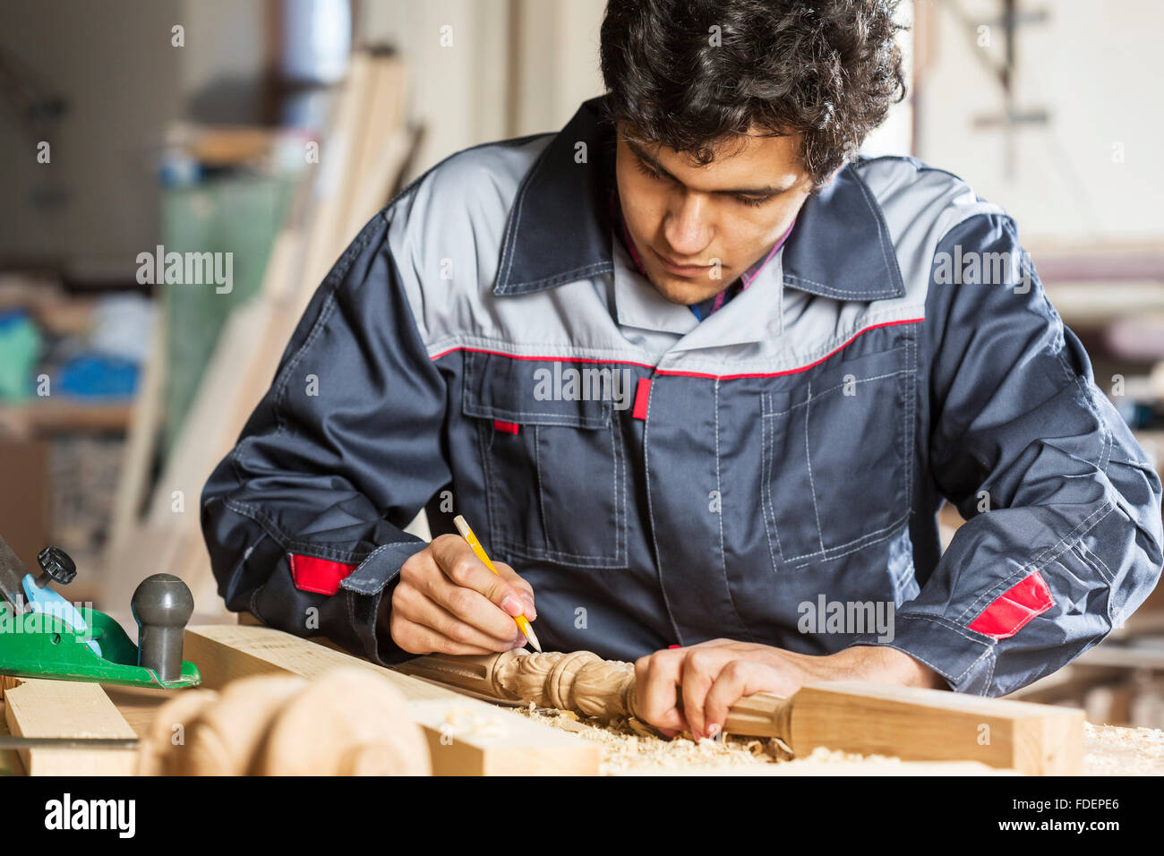 Young carpenter working with cutter in his studio Stock Photo - Alamy