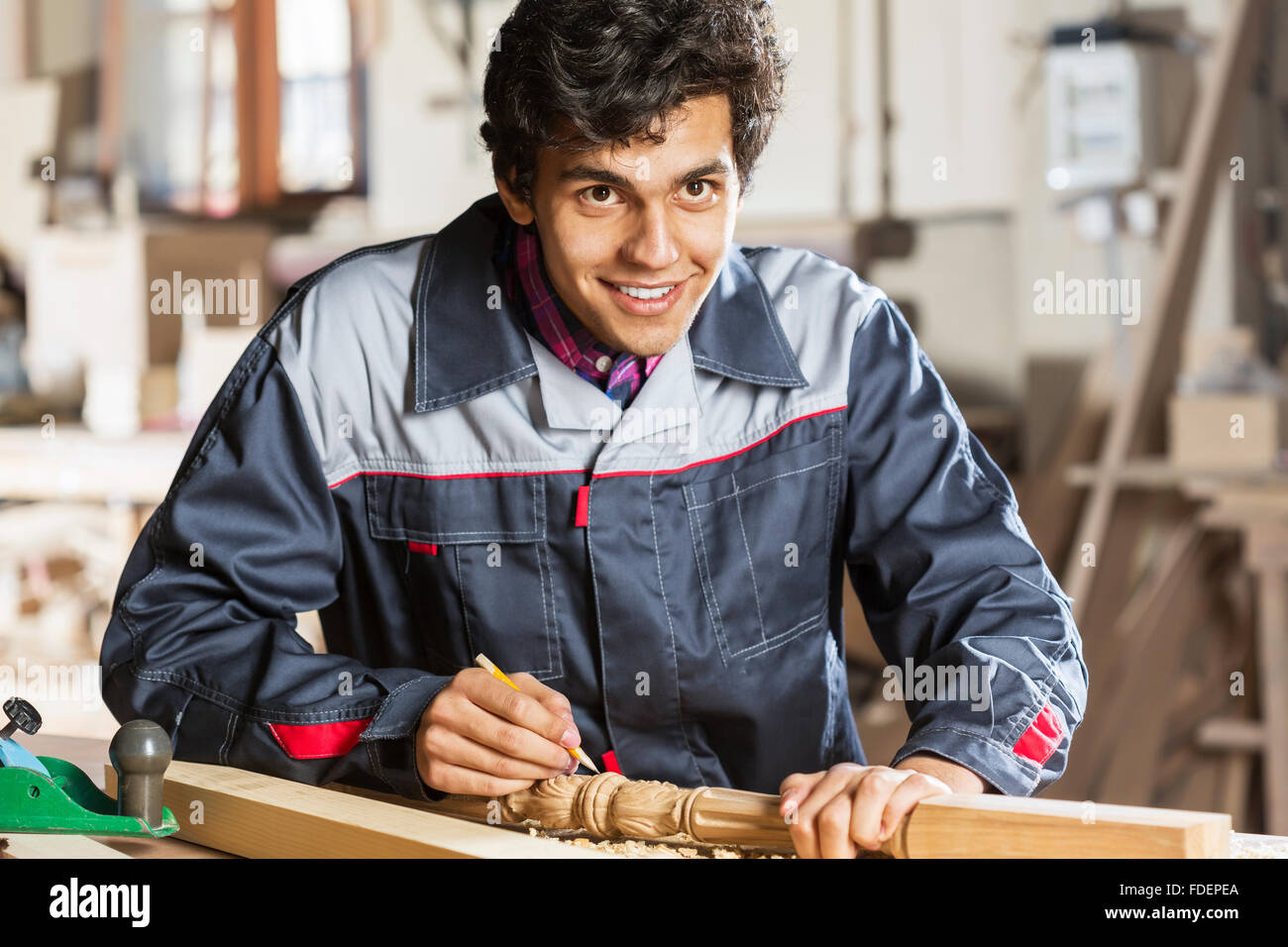 Young carpenter working with cutter in his studio Stock Photo - Alamy