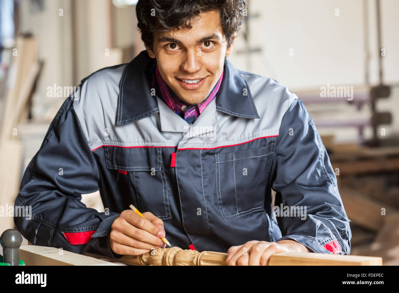 Young carpenter working with cutter in his studio Stock Photo - Alamy